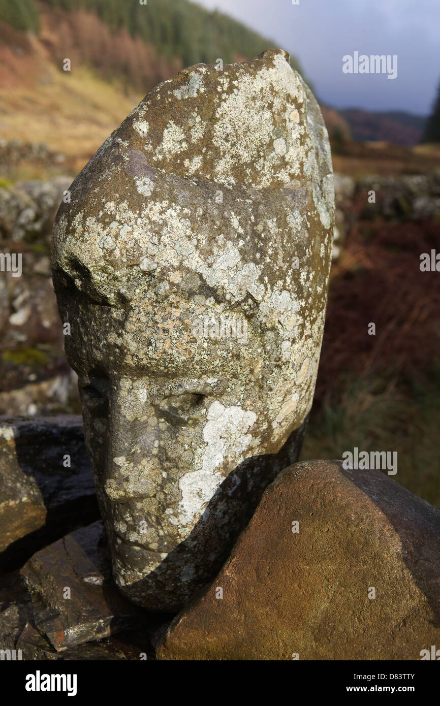 Stone sculpted human faces embedded in a dry stone dyke by Matt Baker ...