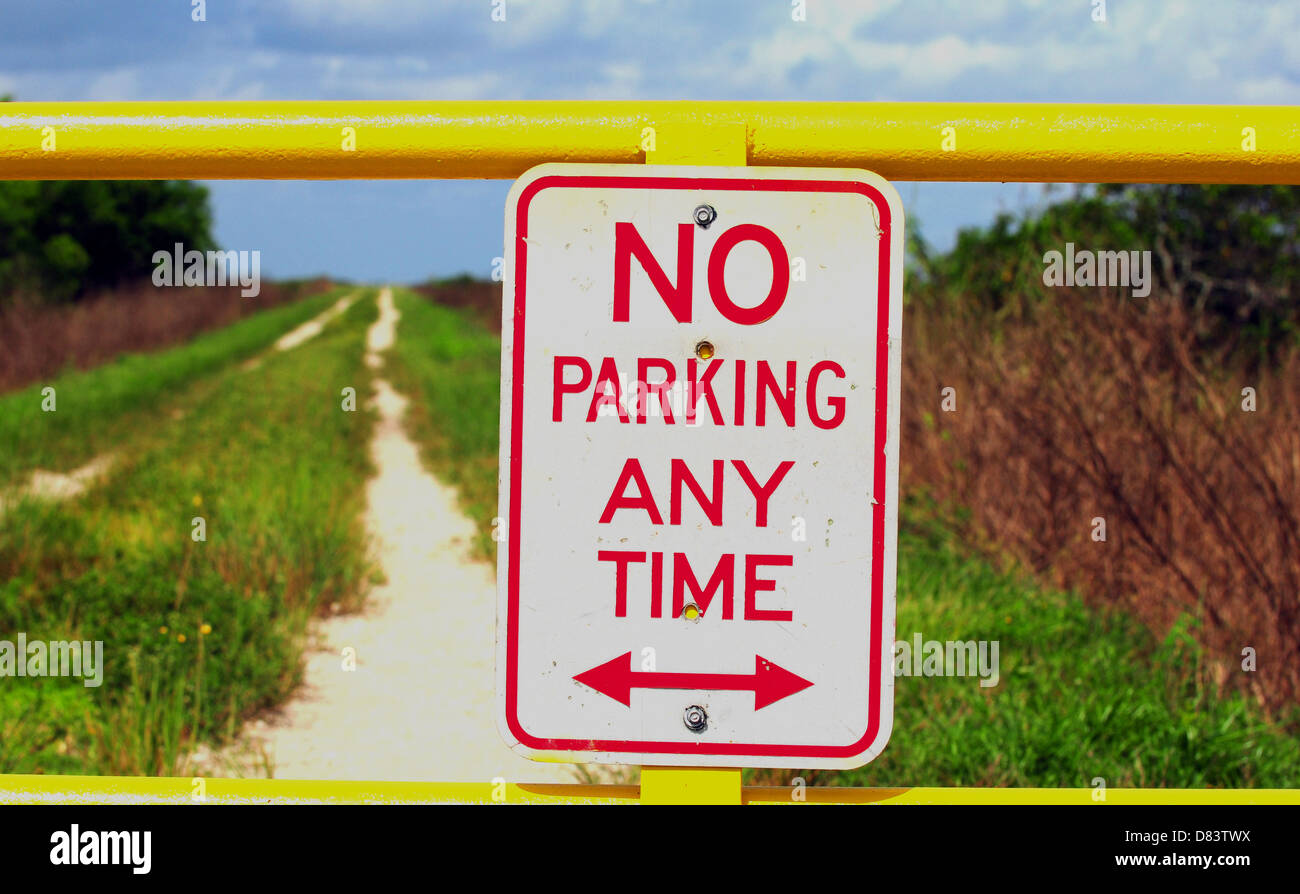 No parking sign and yellow fence against dirt path in country Stock ...