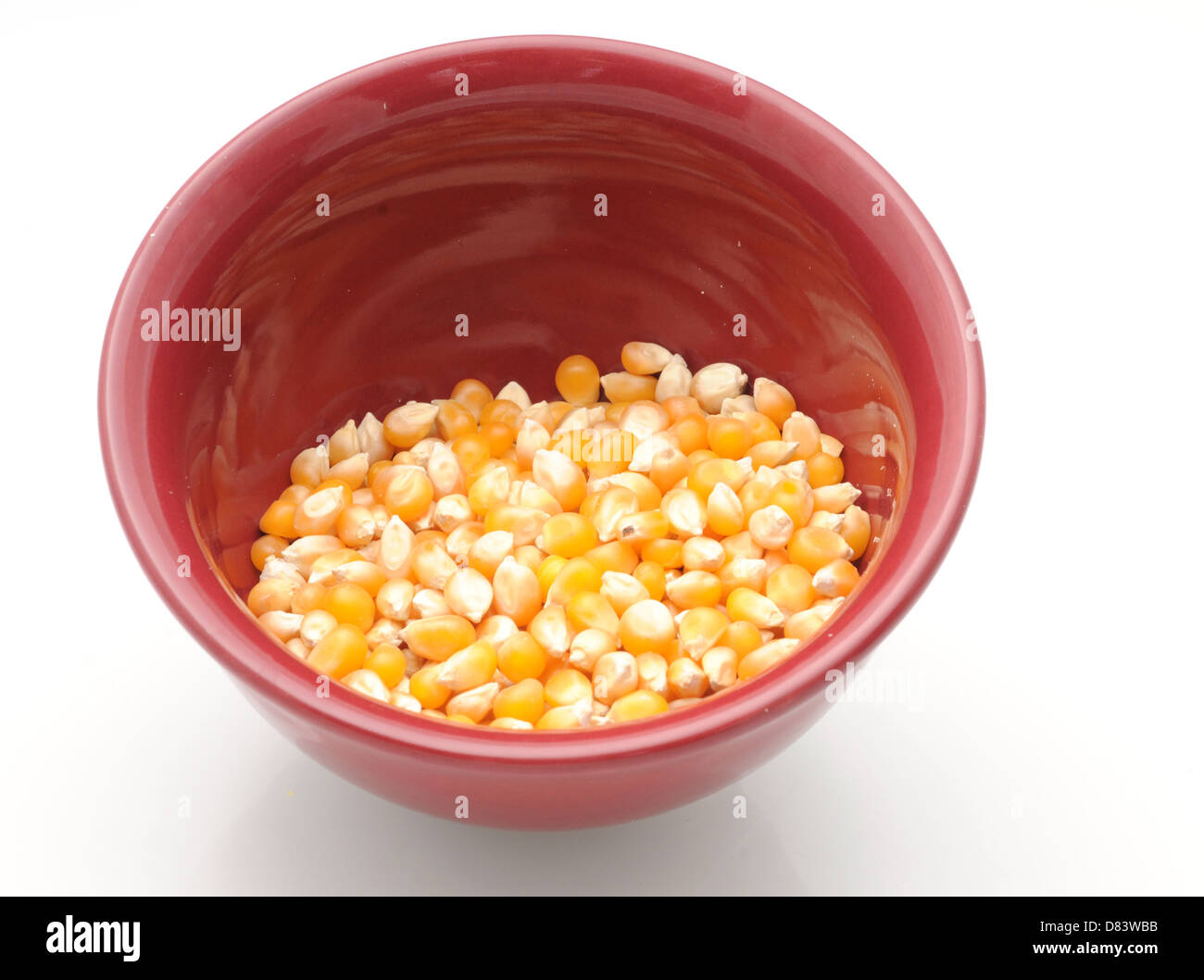 Raw popcorn in a red bowl isolated with nobody Stock Photo - Alamy