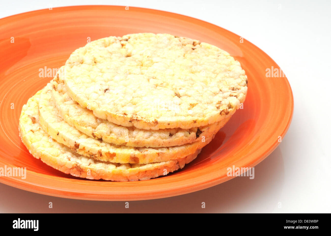 Four rice cakes on an orange plate Stock Photo - Alamy