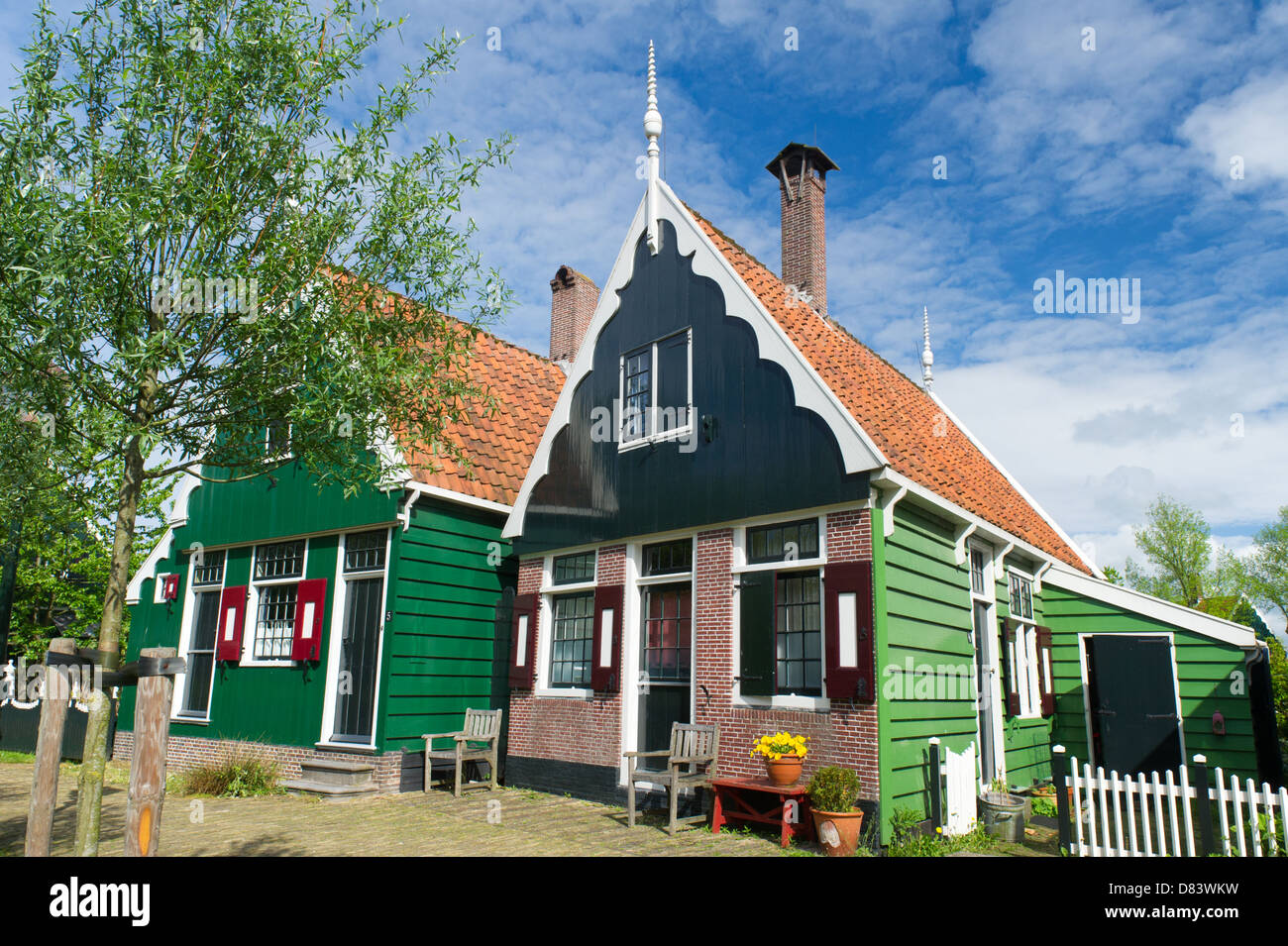 Typical Dutch village with green wooden houses and ditch Stock Photo ...