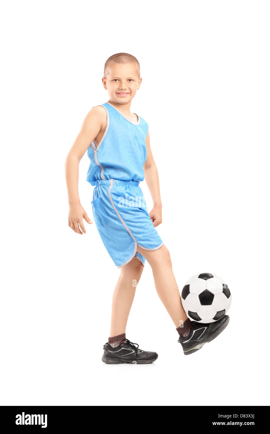 Full length portrait of a child playing with a soccer ball isolated on ...