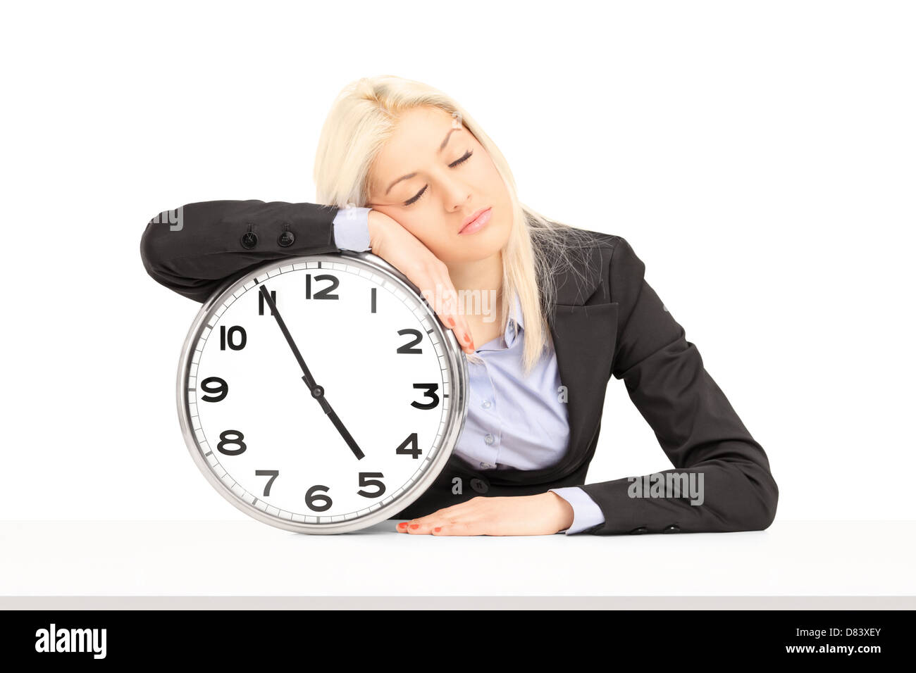 Tired businesswoman sleeping on a wall clock at workplace, isolated on ...