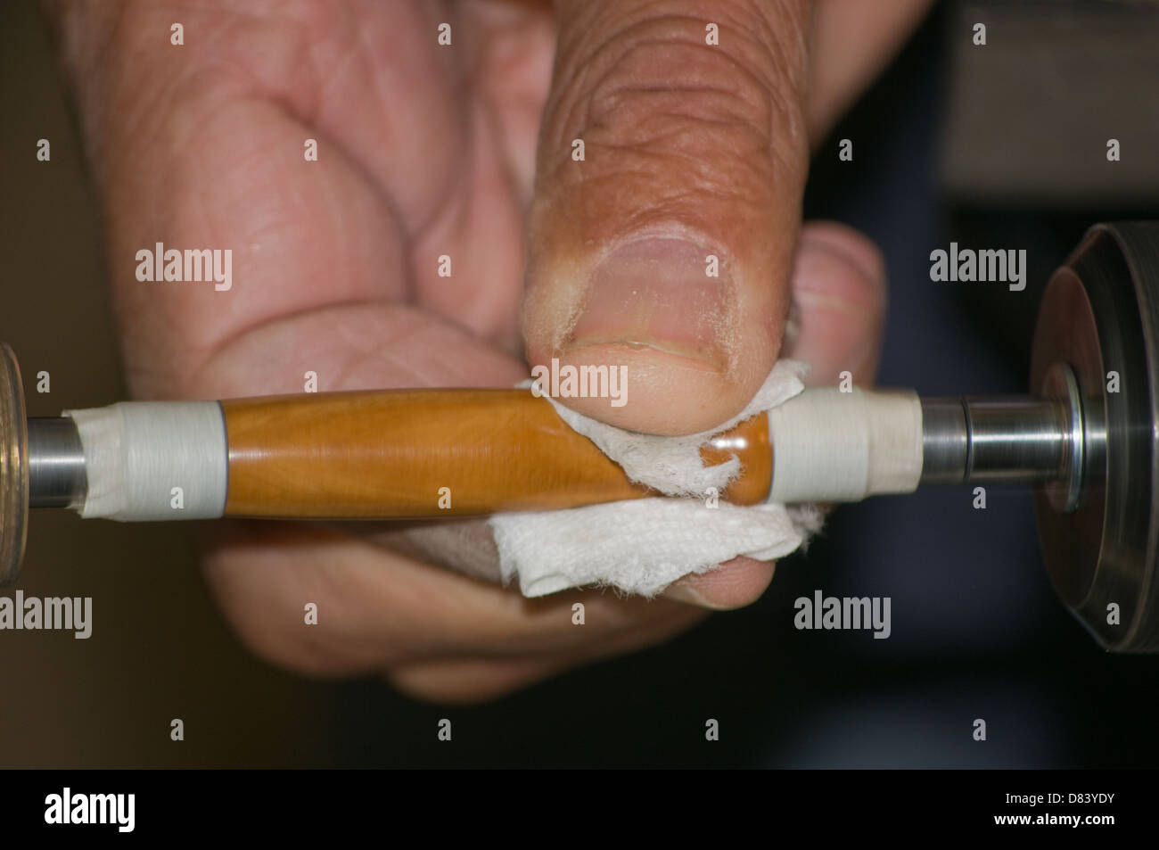 applying friction polish to pen blank Stock Photo - Alamy