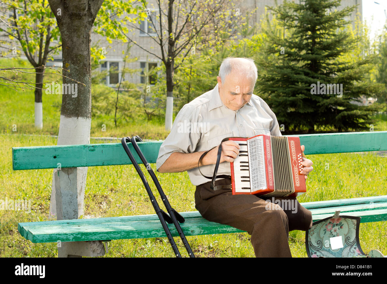 Handicapped senior man with one leg amputated above the knee sitting on ...