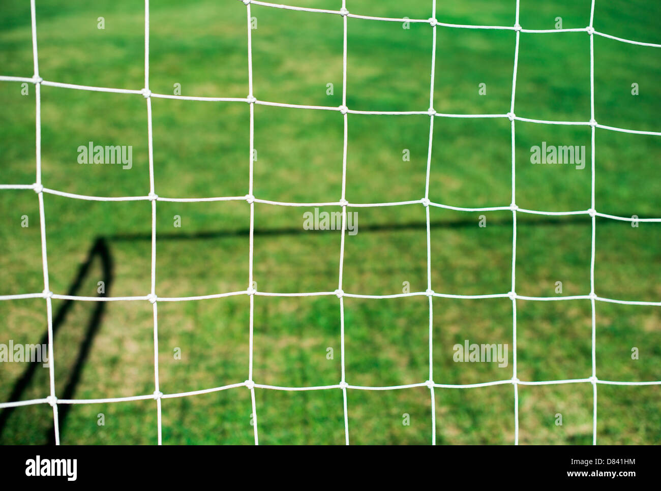 Football net and green grass background Stock Photo - Alamy