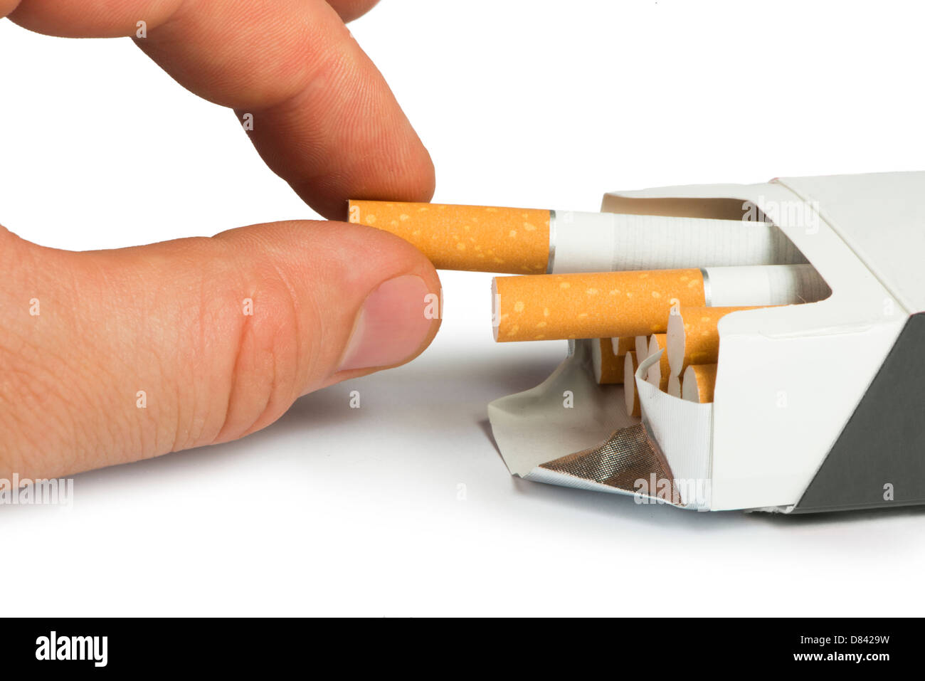 Box of cigarettes.Close up hand takes a cigarette.White isolated studio ...