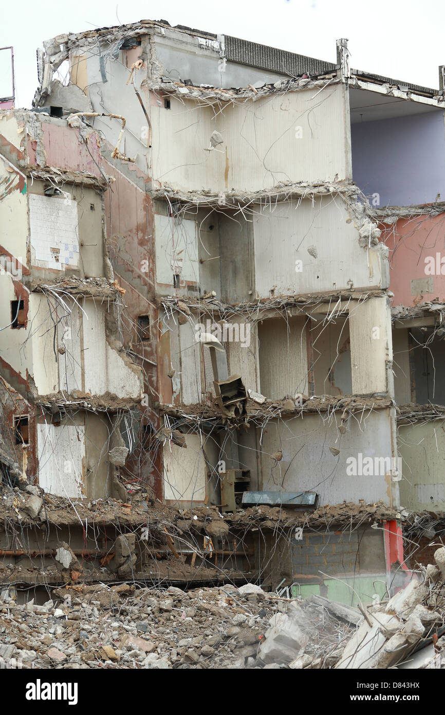 Partially demolished block of flats showing different floor levels ...