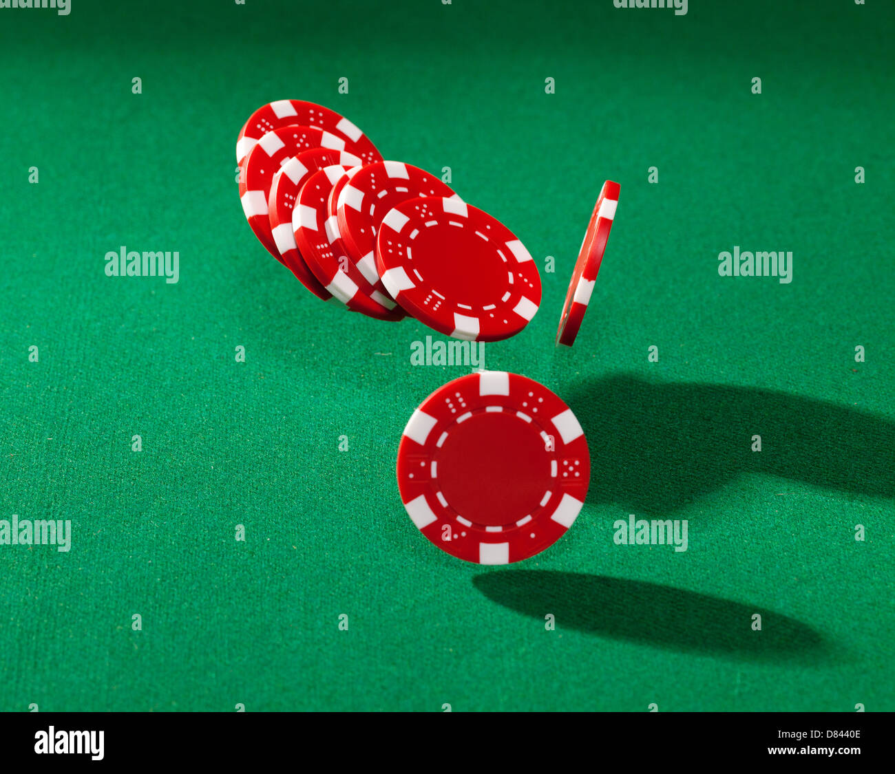 Red poker chips closeup on green cloth Stock Photo - Alamy