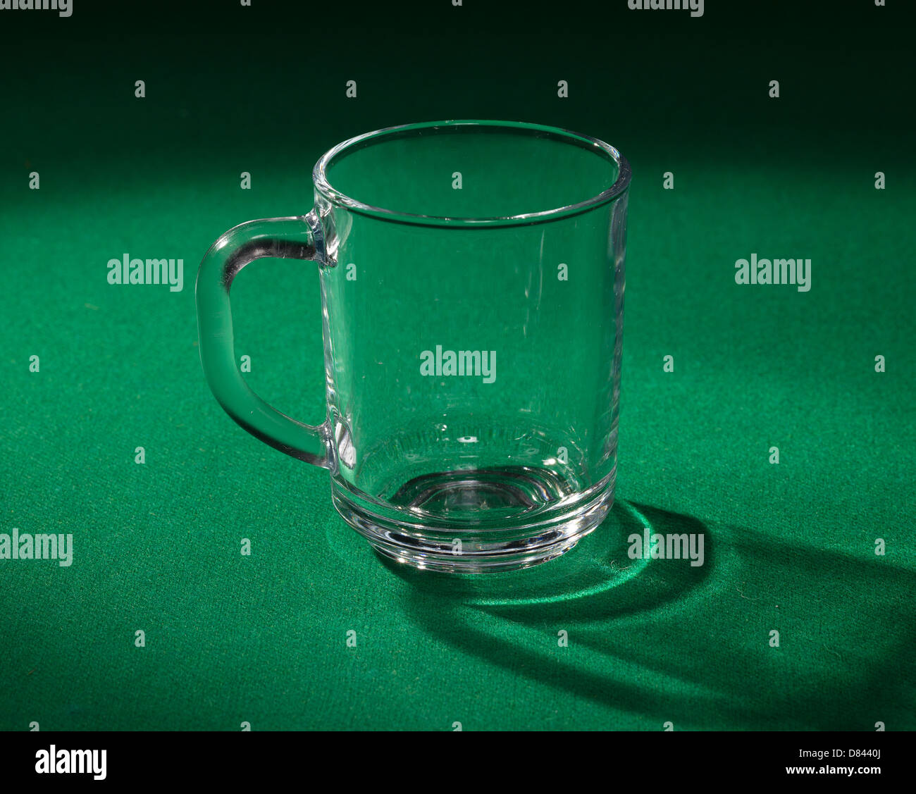 Empty glass beaker on green background Stock Photo - Alamy