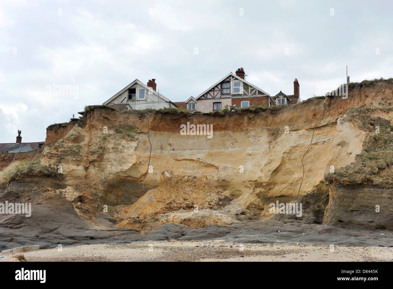 Two homes on the cliffs at Happisburgh in Norfolk suffering from high ...