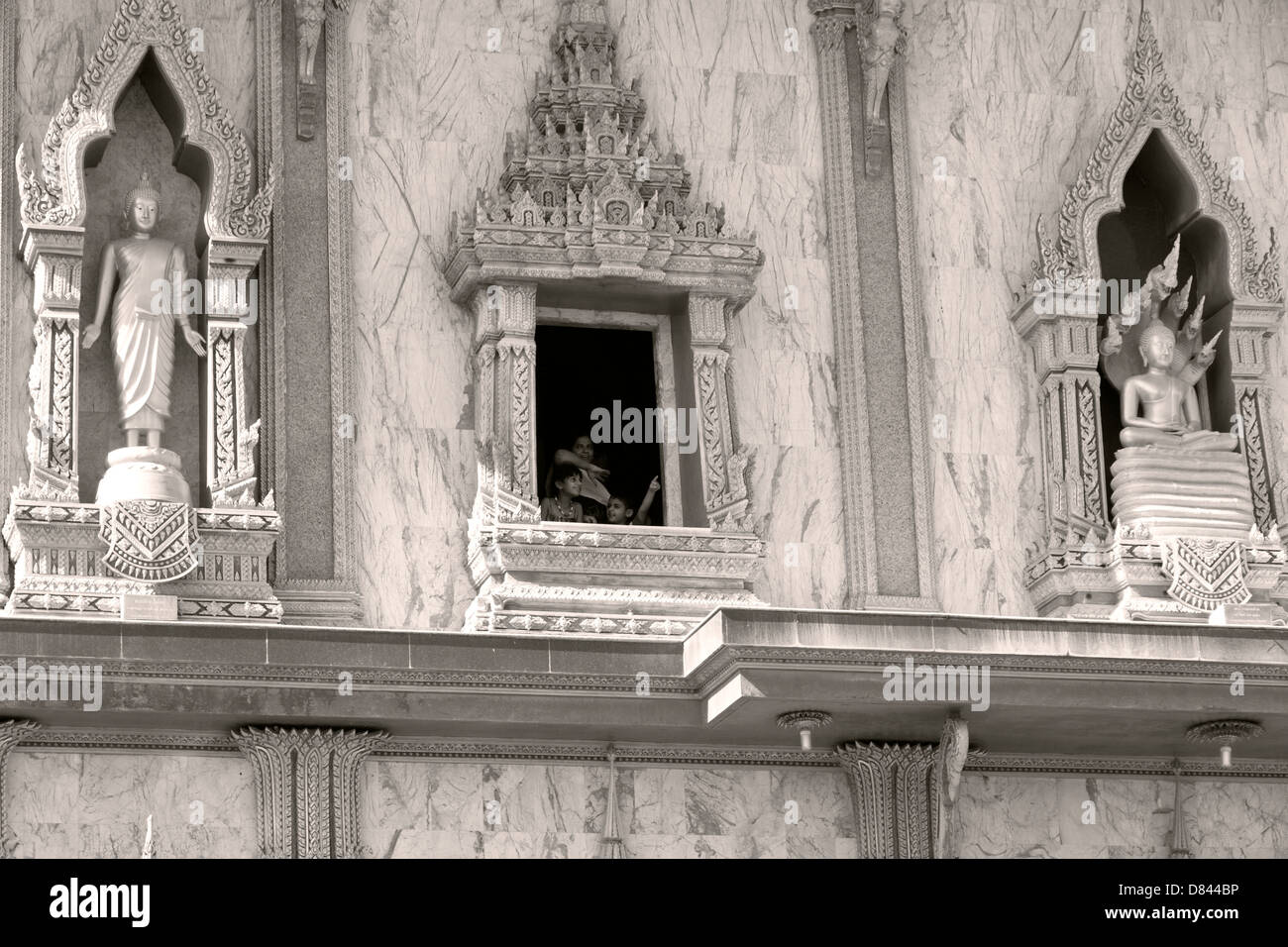 PHUKET, THAILAND APRIL 28 2013: Family look out window main stupa at ...