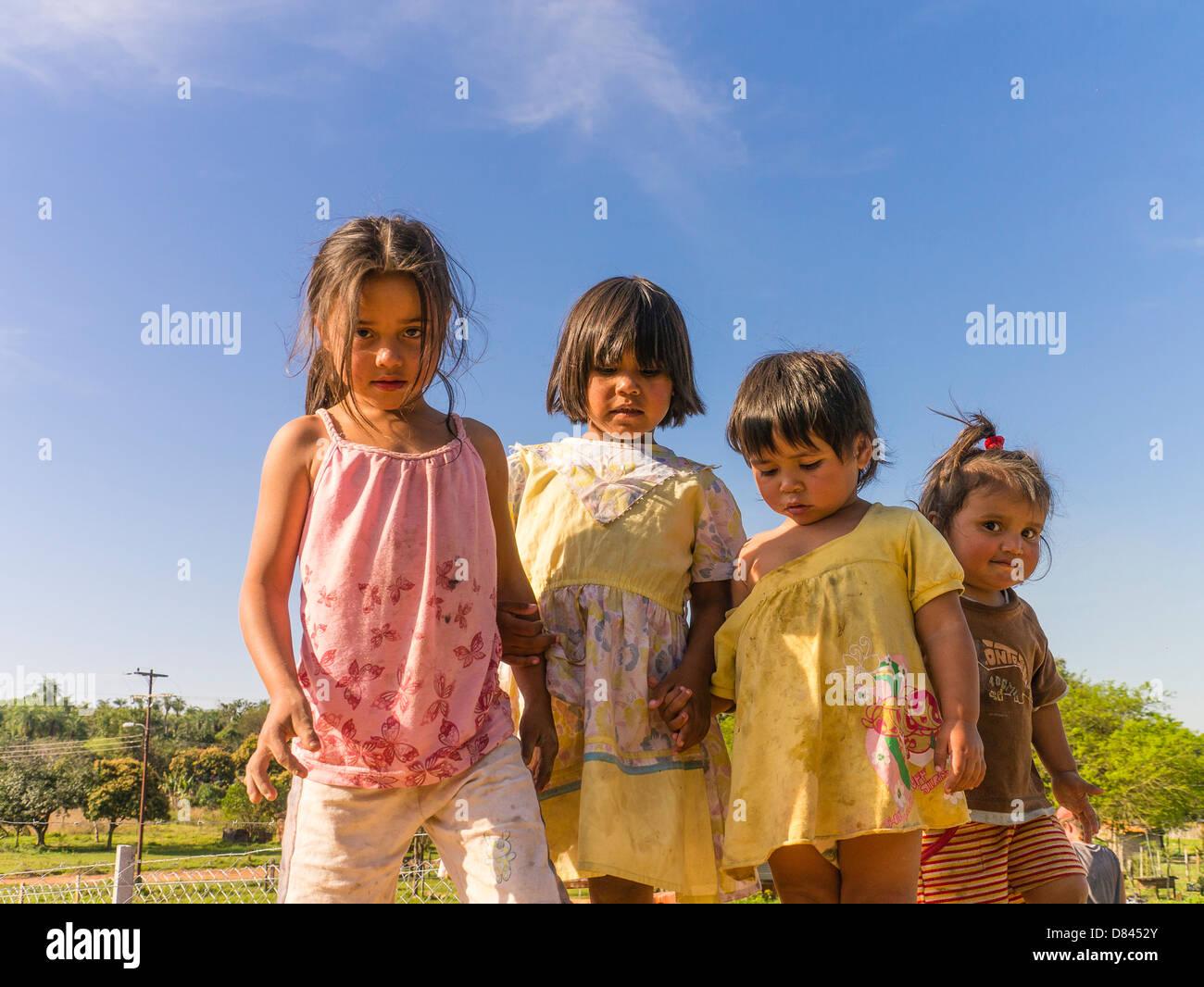 Four young Hispanic sisters stand side by side facing forward in Luque ...