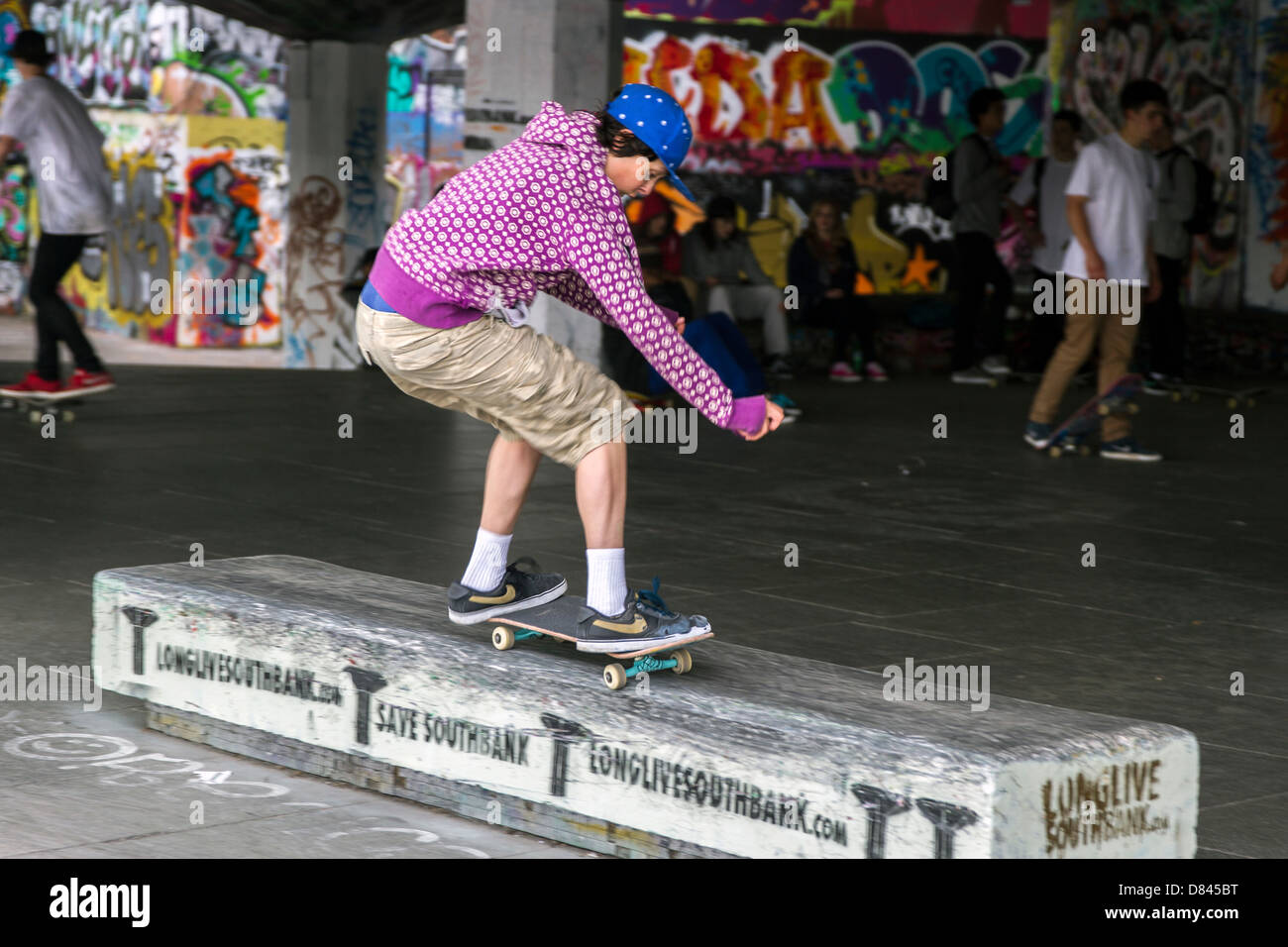 Teenager sliding a skateboard across bench Stock Photo - Alamy