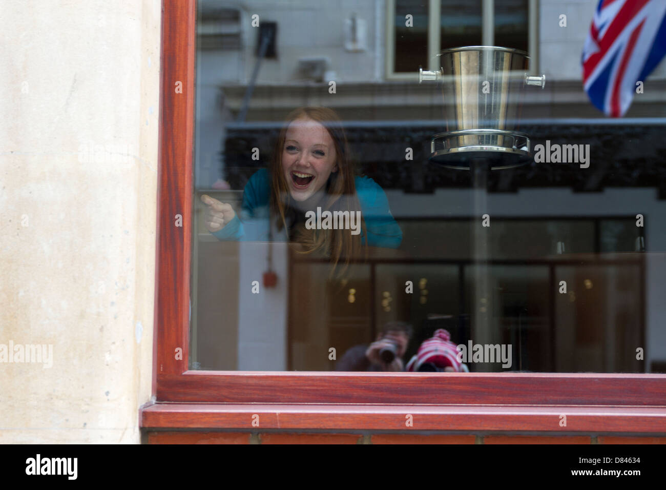 Women laughing in office window Stock Photo - Alamy