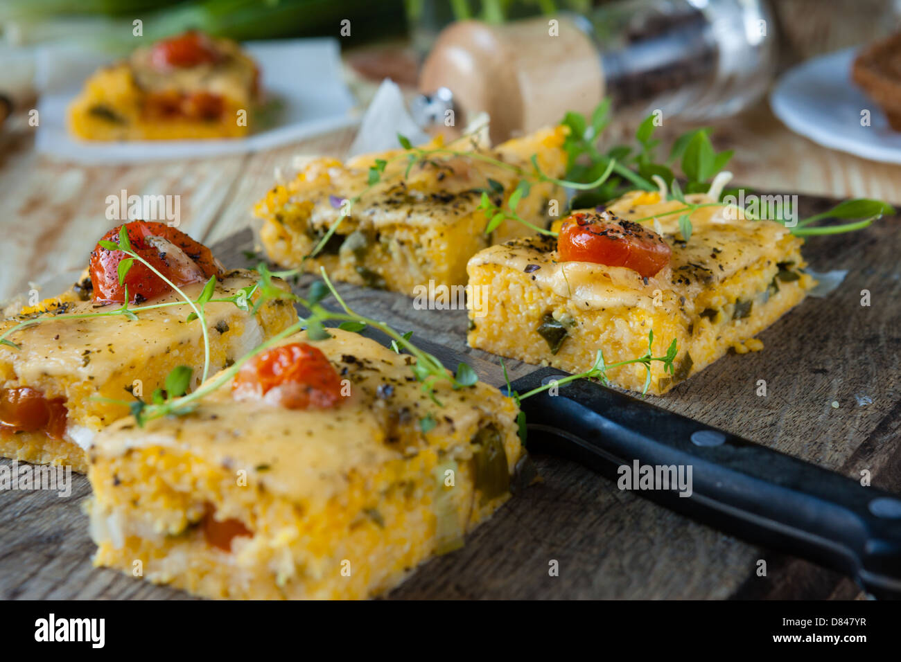 polenta with cheese cut into small squares on the board, closeup Stock ...