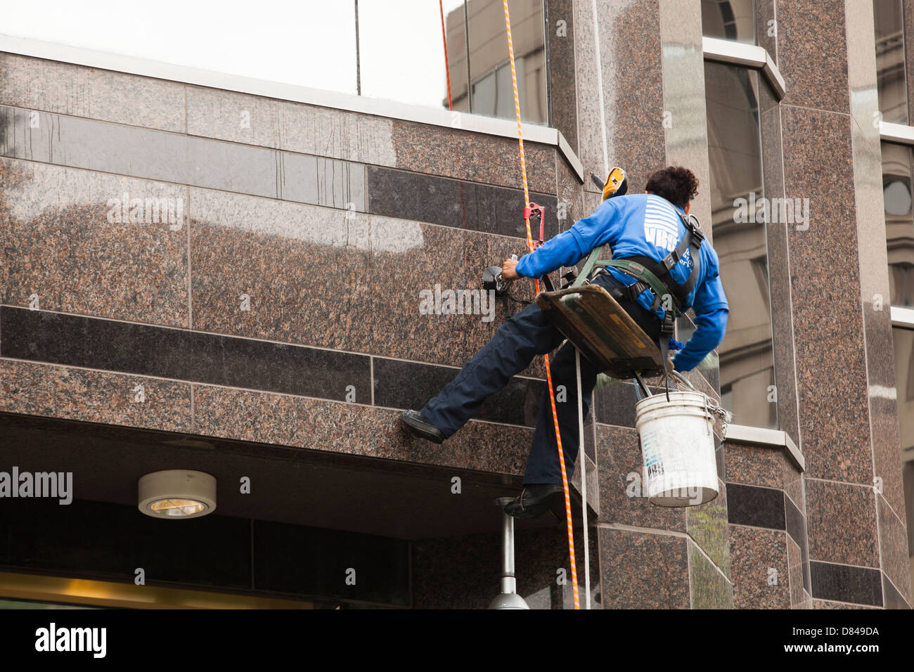 High rise building window washer repelling from job - USA Stock Photo ...