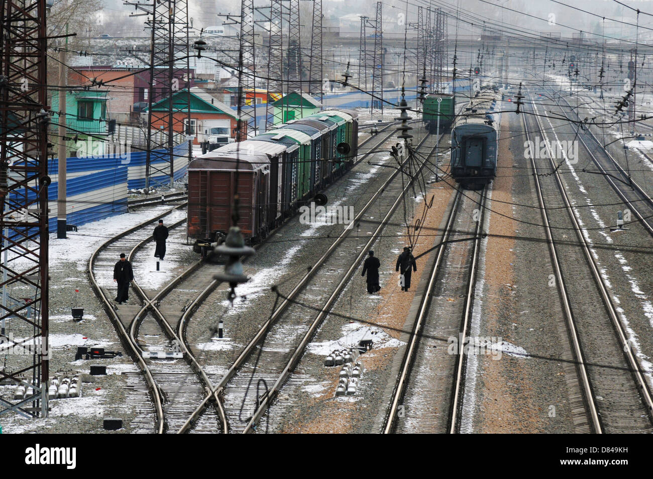 Trains and people at the rail road station in provincial Russian town ...