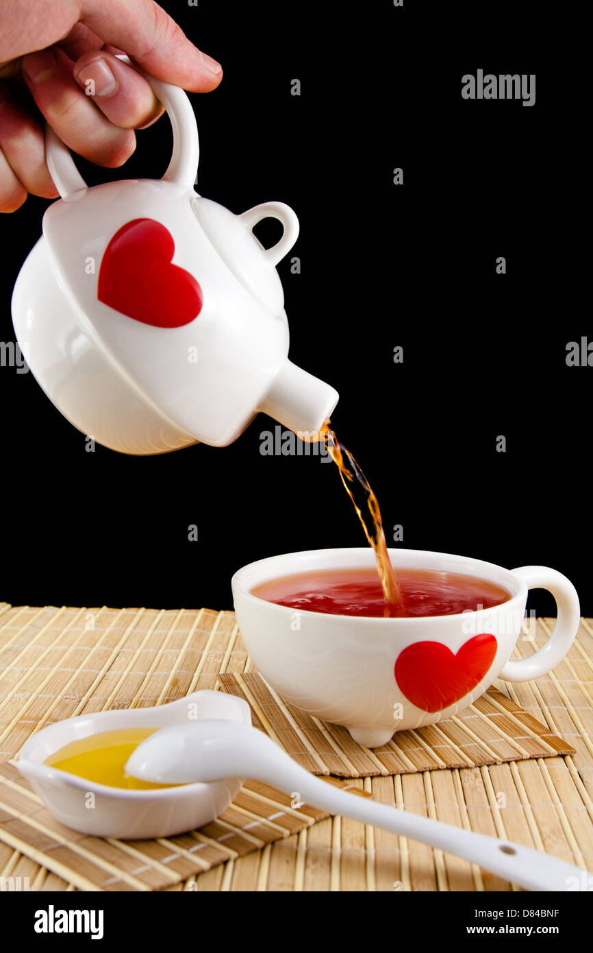 Hand pouring healthy herbal tea hi-res stock photography and images - Alamy