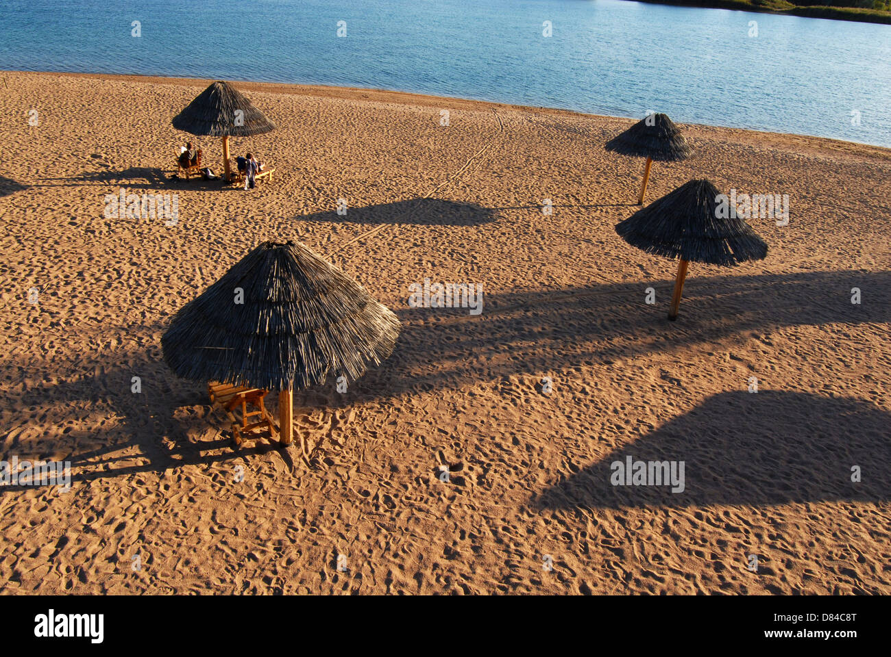 Few shelters at the beach of the Issyk Kul lake an the sunset. Issyk ...