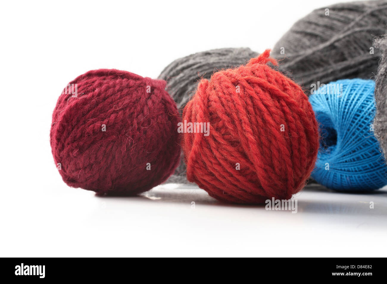 Several balls of wool on a white background Stock Photo - Alamy
