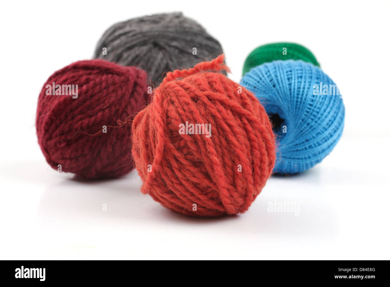 Several balls of wool on a white background Stock Photo - Alamy