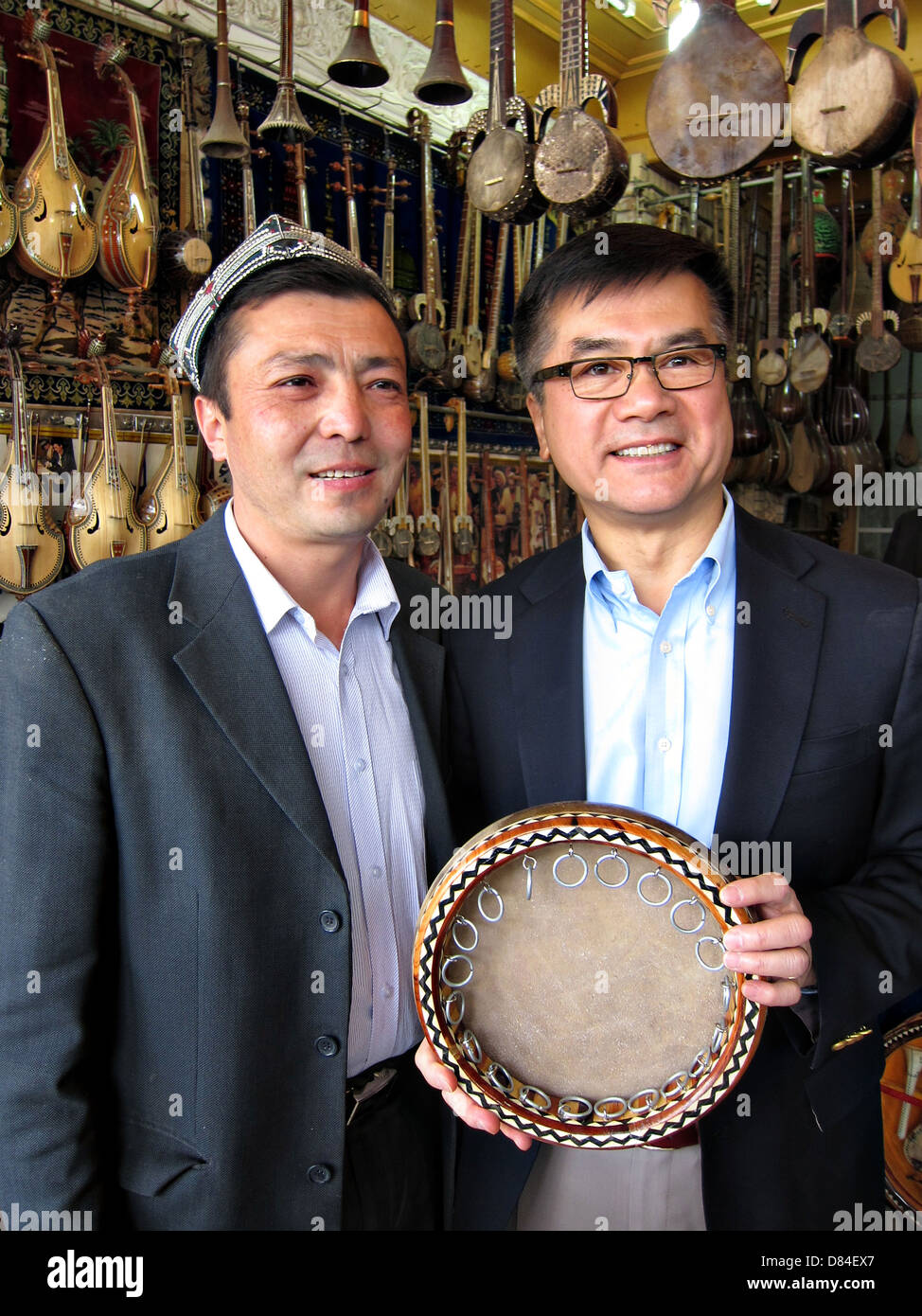 US Ambassador Gary Locke is given a traditional musical instrument by a ...
