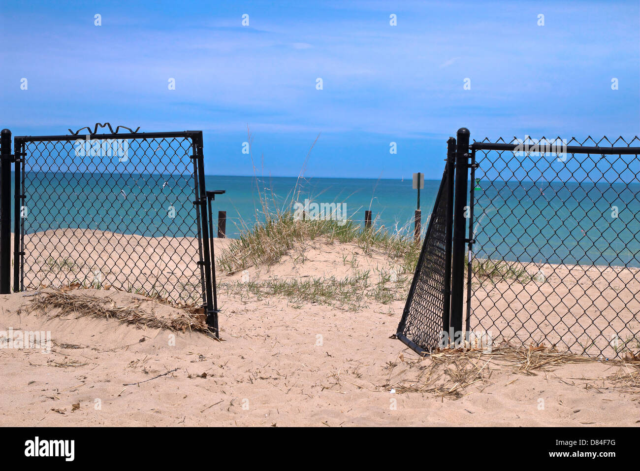 Gate opening onto the beach announcing the beginning of summer Stock ...