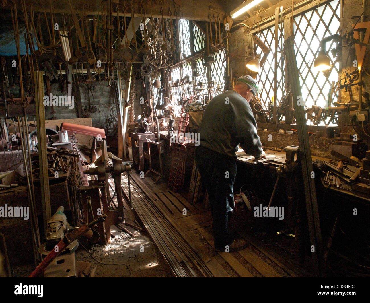 A blacksmith in his forge, in the small village of Glynde, East Sussex ...