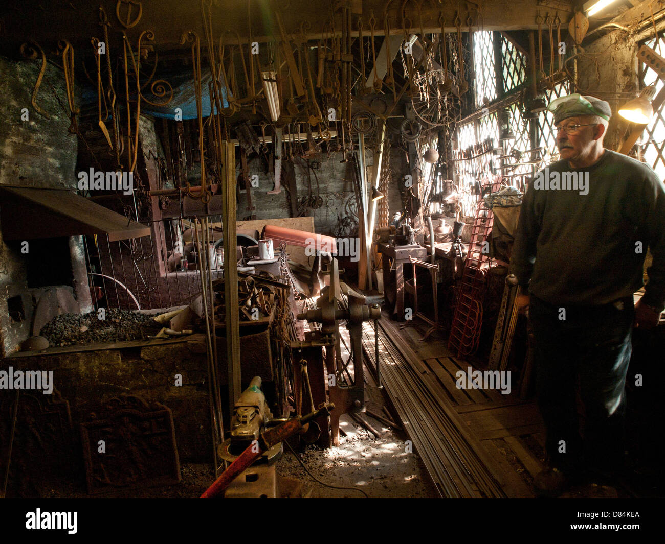 A blacksmith in his forge, in the small village of Glynde, East Sussex ...