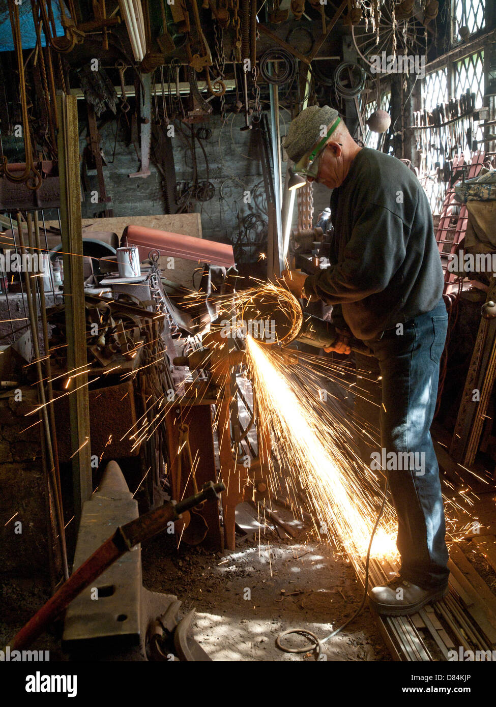 A blacksmith in his forge, in the small village of Glynde, East Sussex ...