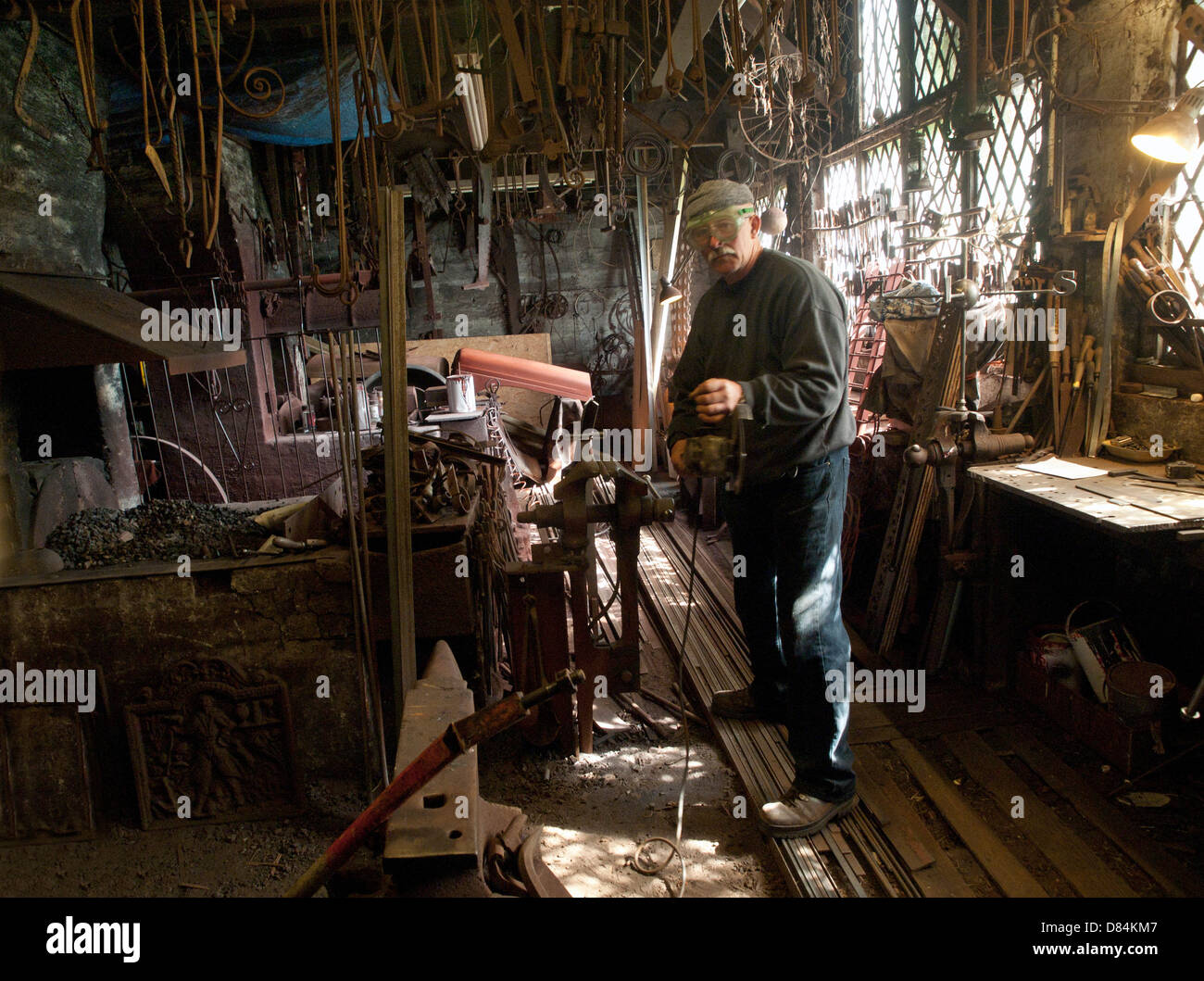 A blacksmith in his forge, in the small village of Glynde, East Sussex ...