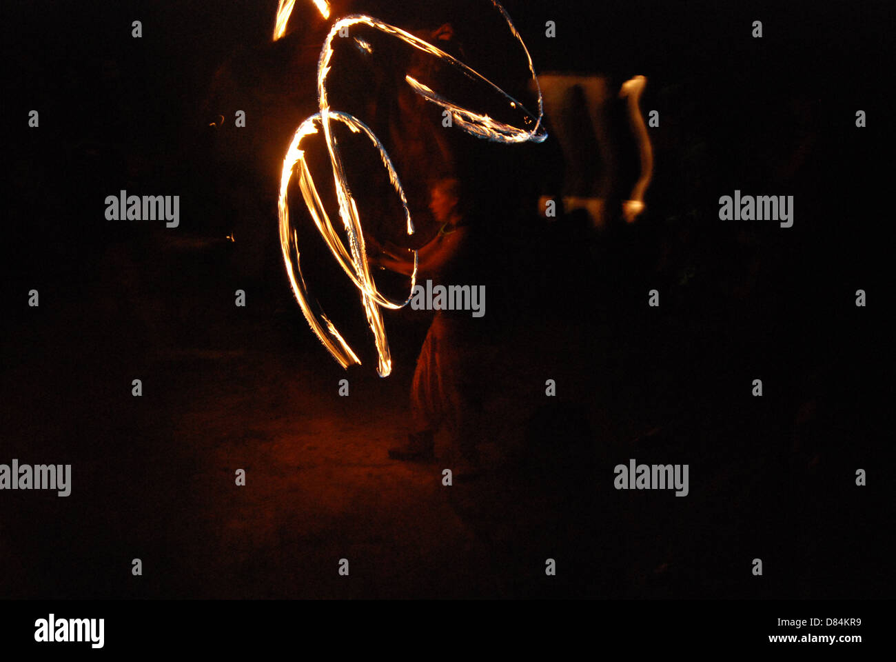 A fire spinner at a party in Cornwall Stock Photo - Alamy