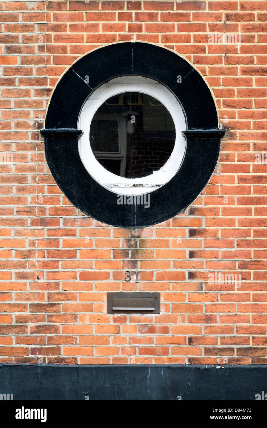 Circular round window with letterbox below Stock Photo - Alamy