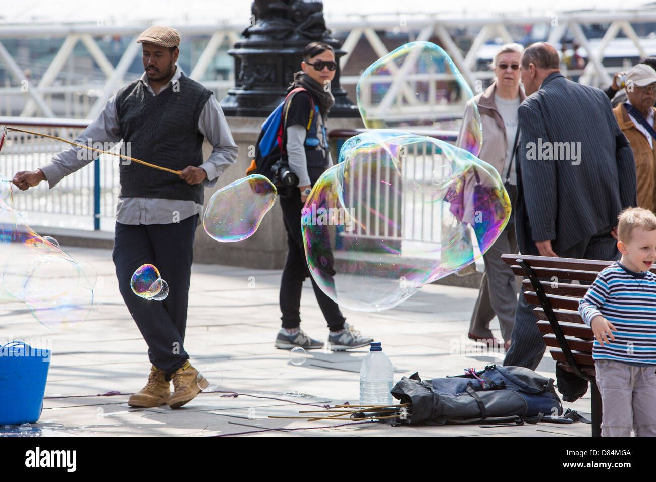 Children chasing bubbles made by a street entertainer on London's South ...