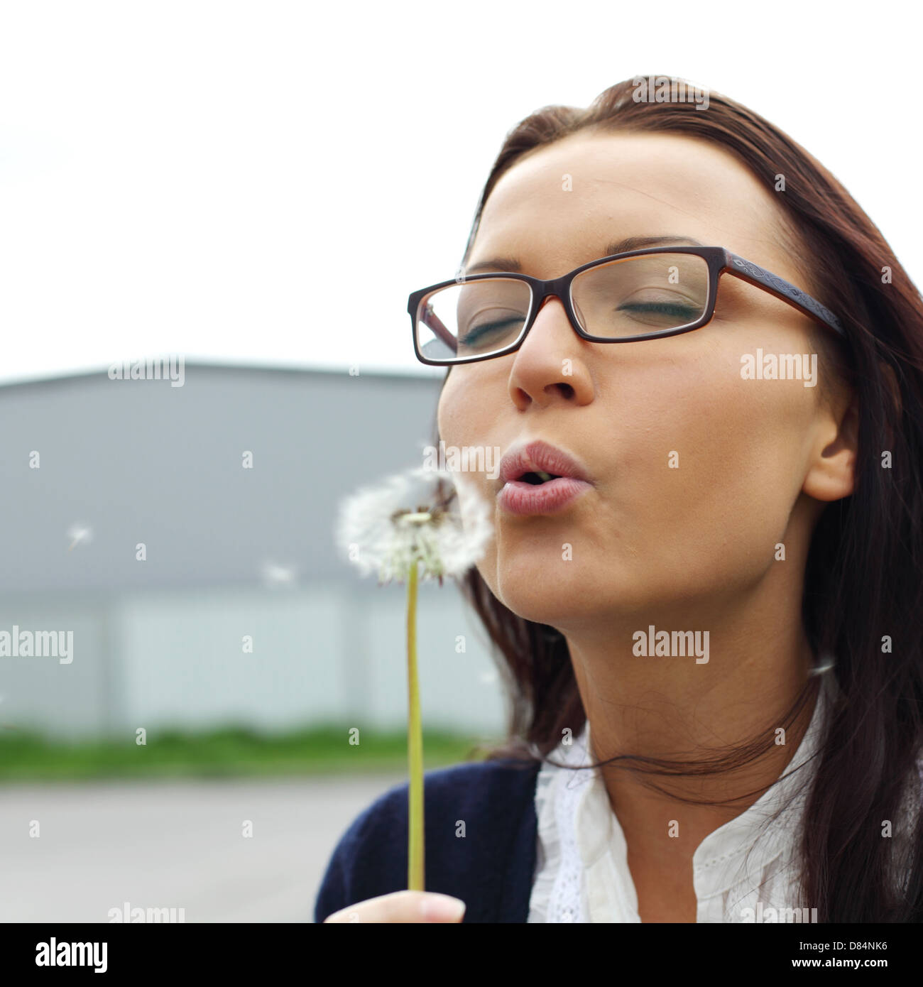 woman blow on dandelion Stock Photo - Alamy
