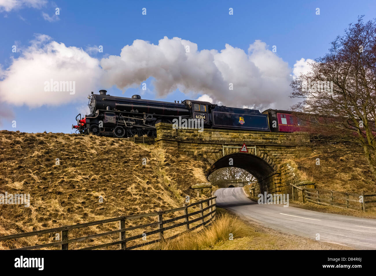 Vintage steam train crosses small bridge in the North York Moors near ...