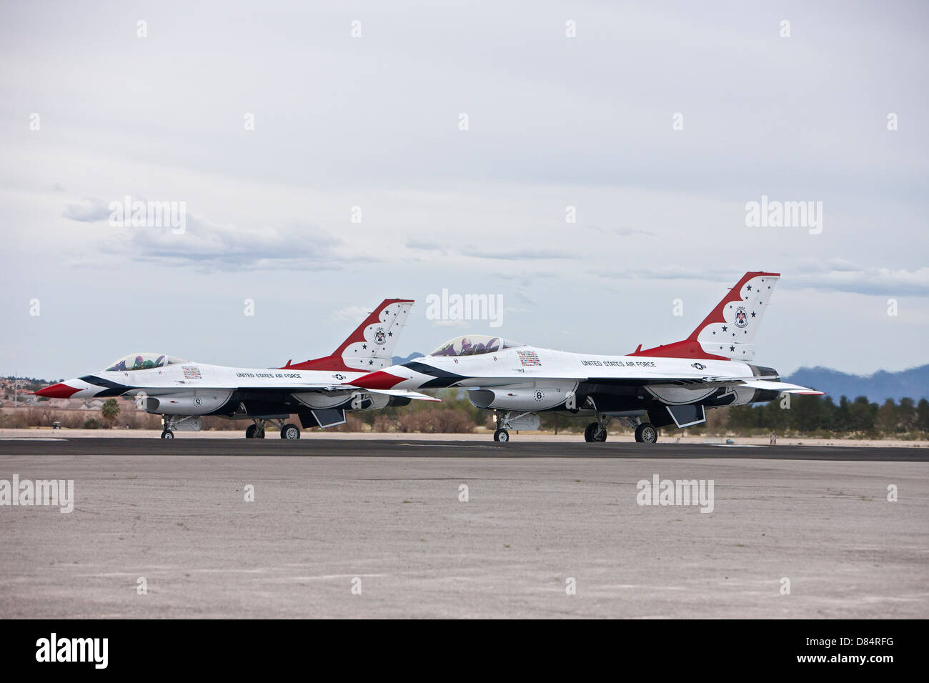 Two F-16C Thunderbirds sit on the runway at Nellis Air Force Base ...
