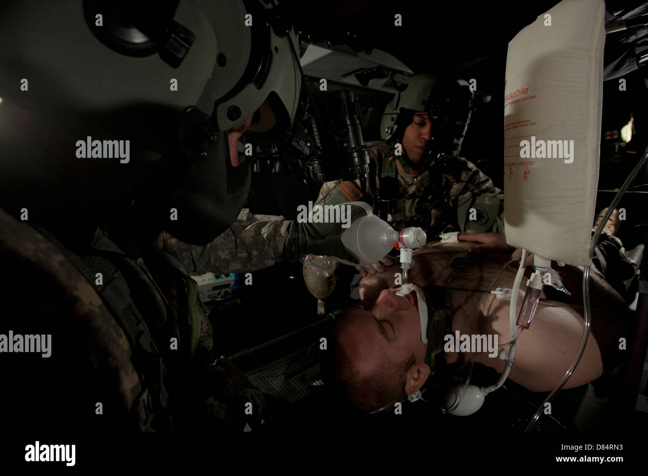 U.S. Army medics simulating ventilation of a mock patient aboard a UH ...