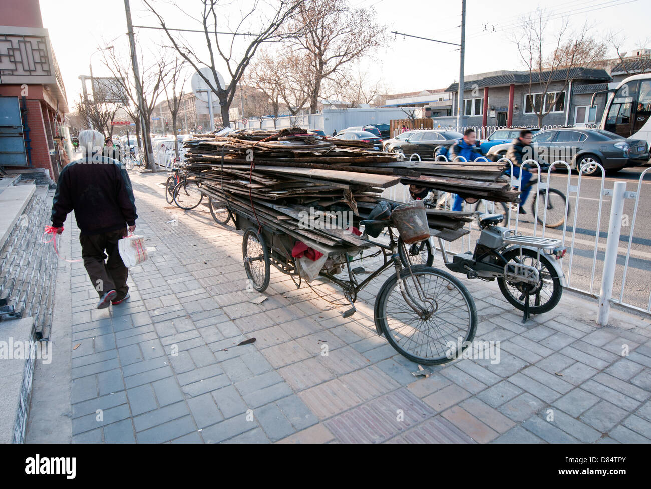Bike loaded with old planks and wood on pavement in Beijing, China ...