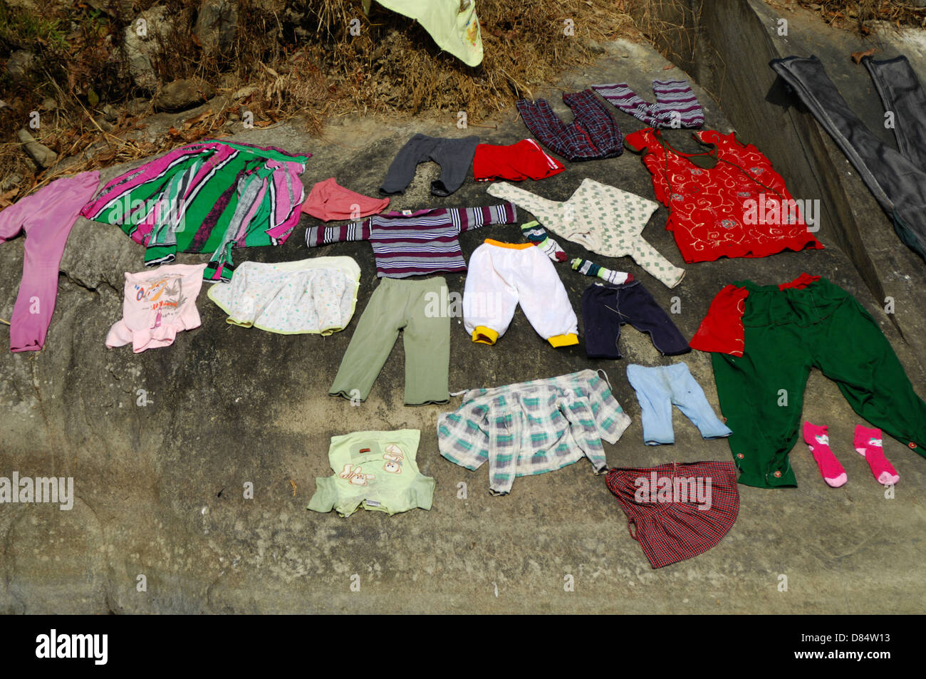 Wash clothes on rock hi-res stock photography and images - Alamy