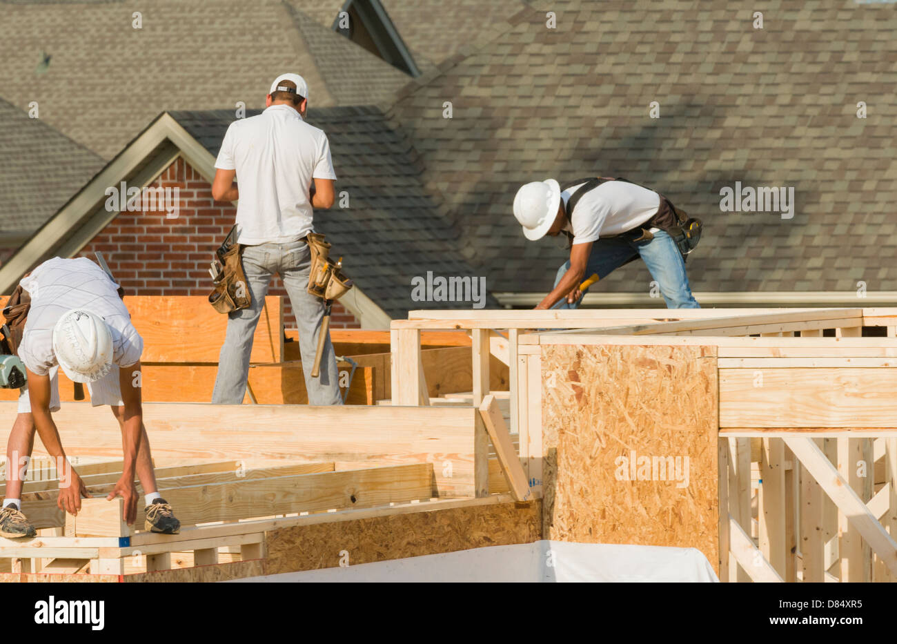 Construction workers framing the studs for a new home Stock Photo - Alamy