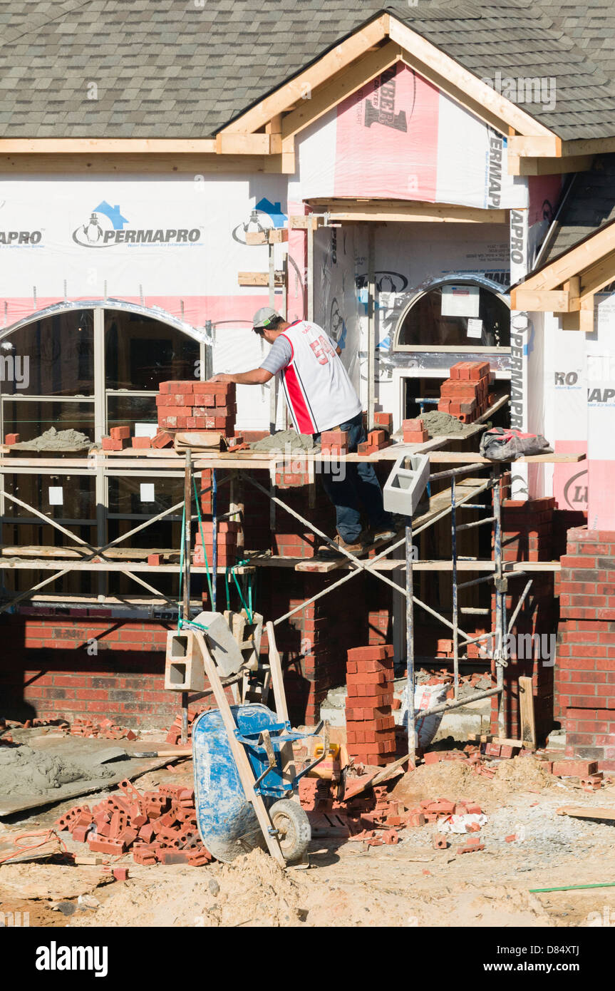 Construction workers laying brick on a new house Stock Photo - Alamy