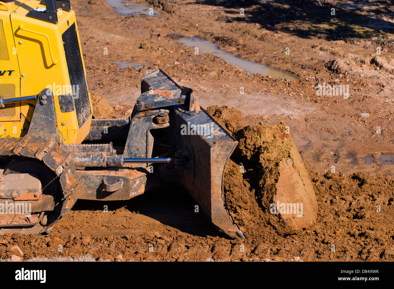 Bulldozer moving dirt on an empty residential new home construction lot ...