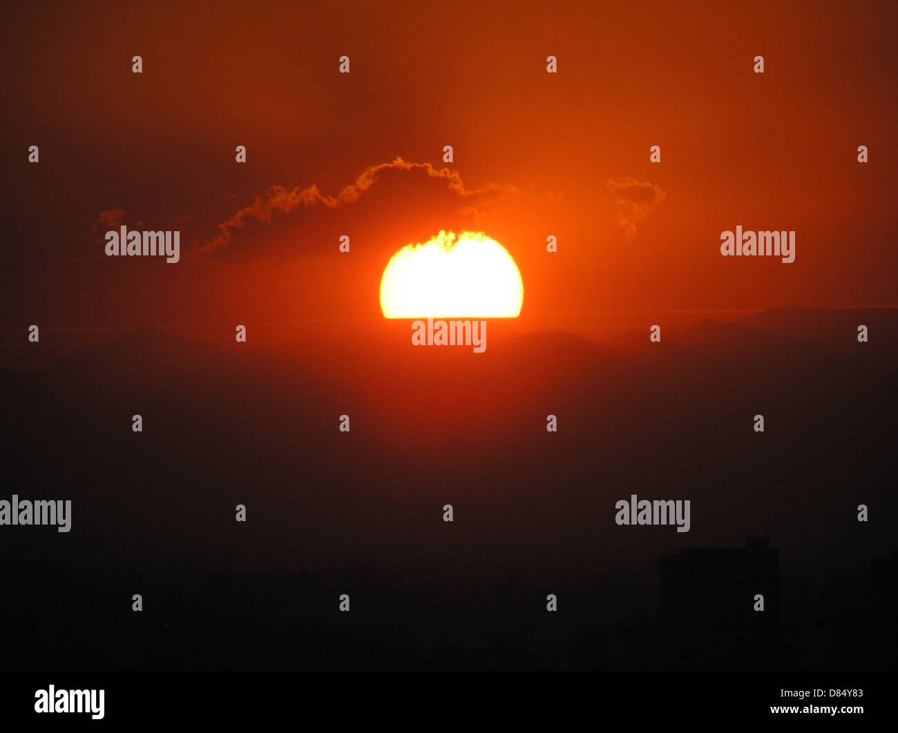 This image captures a sunset over Tokyo on October 2, 2003, showcasing ...