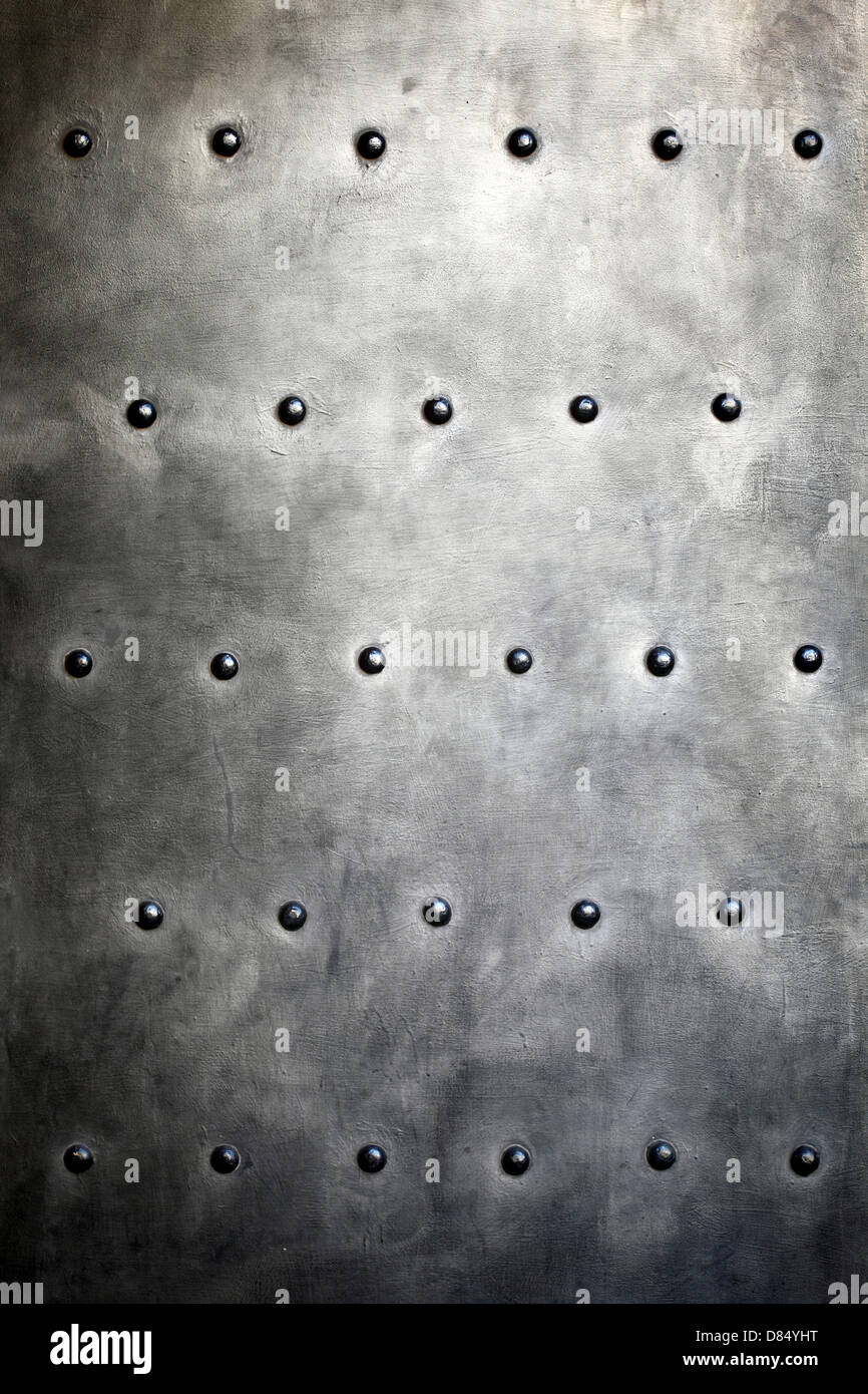 Black grunge metal plate or armour texture with rivets as background ...