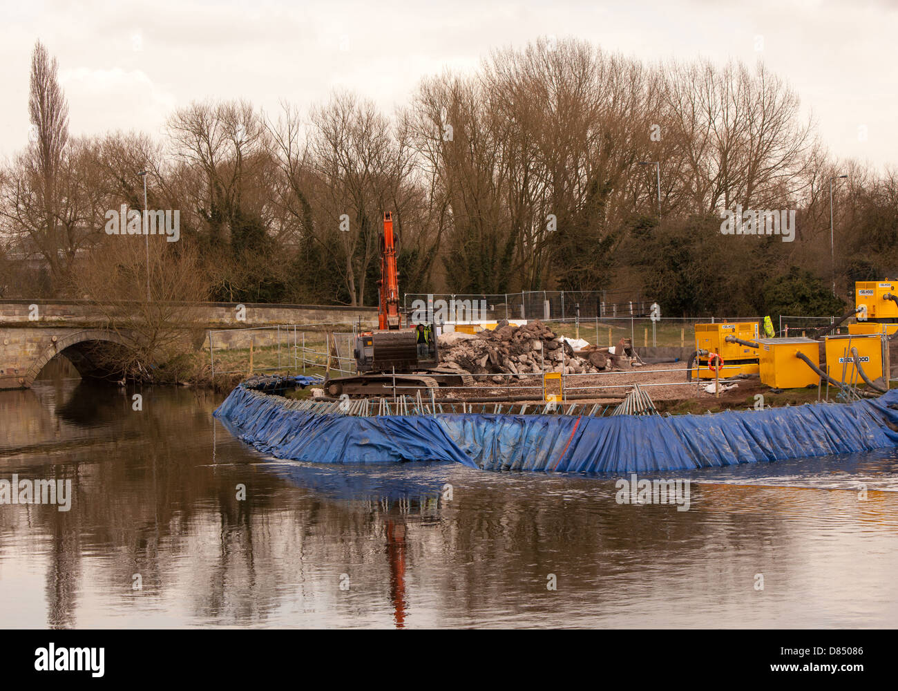 An Hitachi mechanical digger working on constructing a fish pass Stock ...