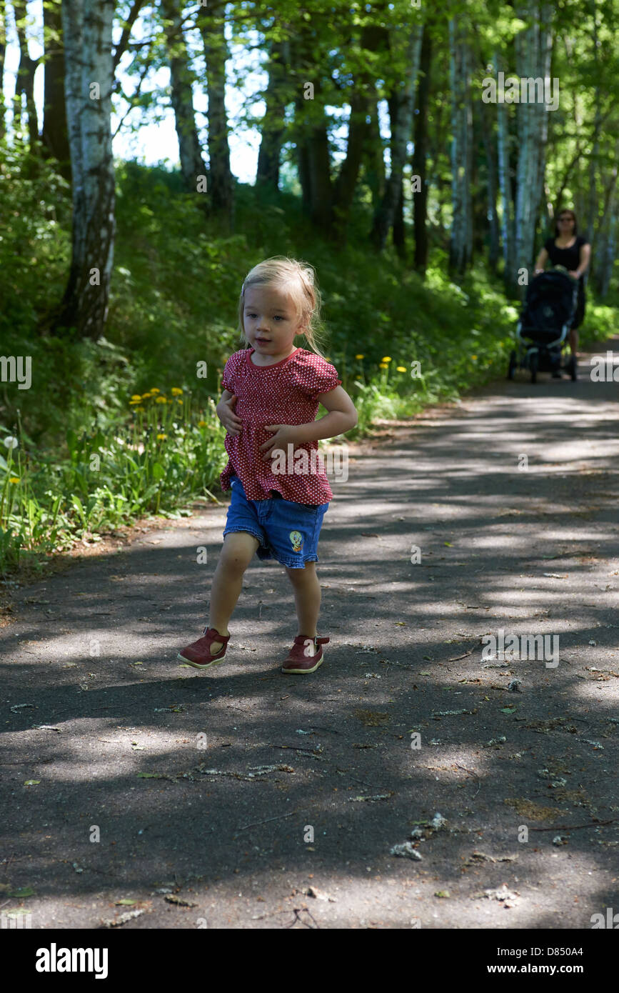 A mother with pushing pram summertime on bike way Stock Photo - Alamy