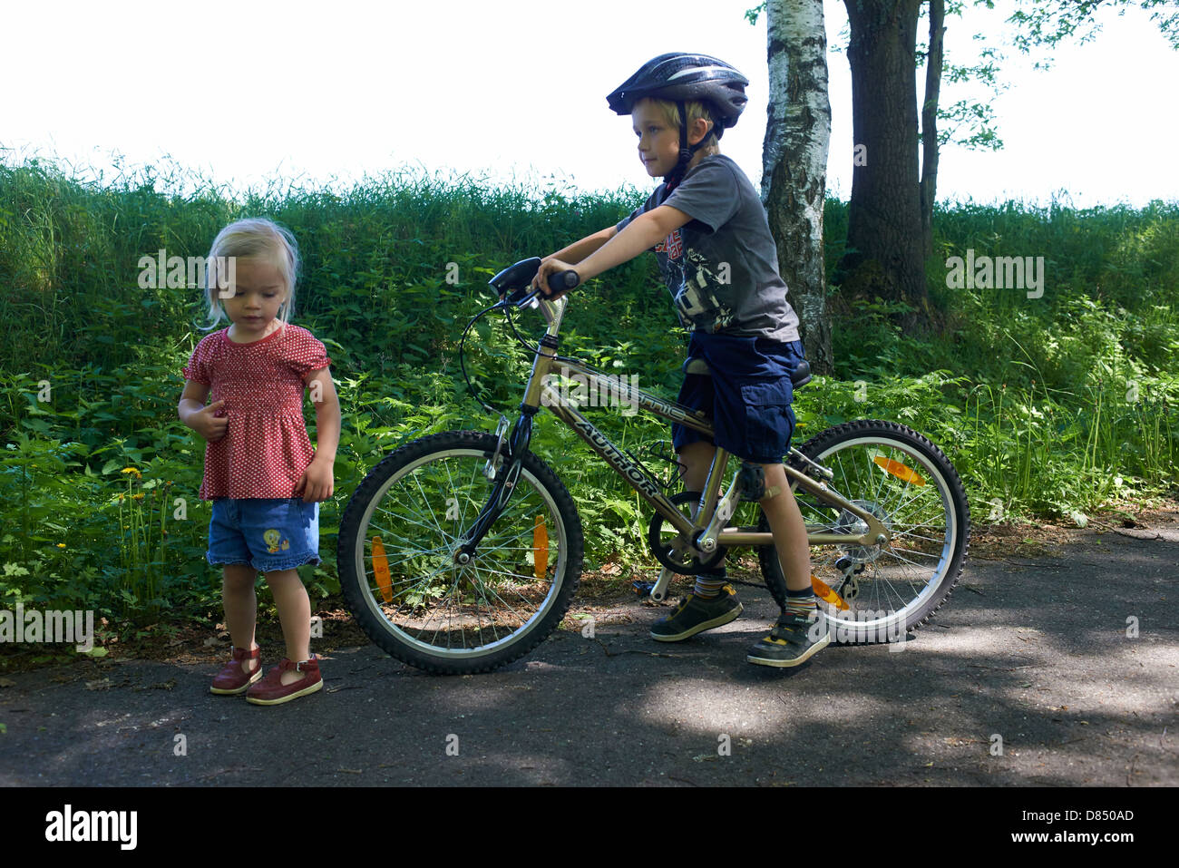 Children sister and brother on the bike path, summertime, siblings ...