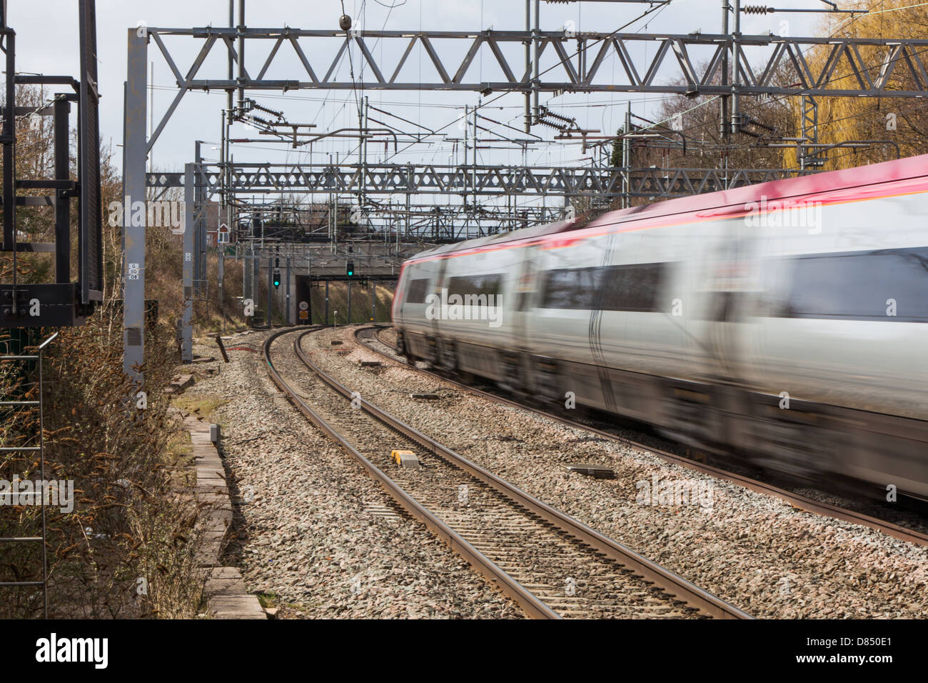 A Virgin train speeds through Tamworth station on the low level line ...